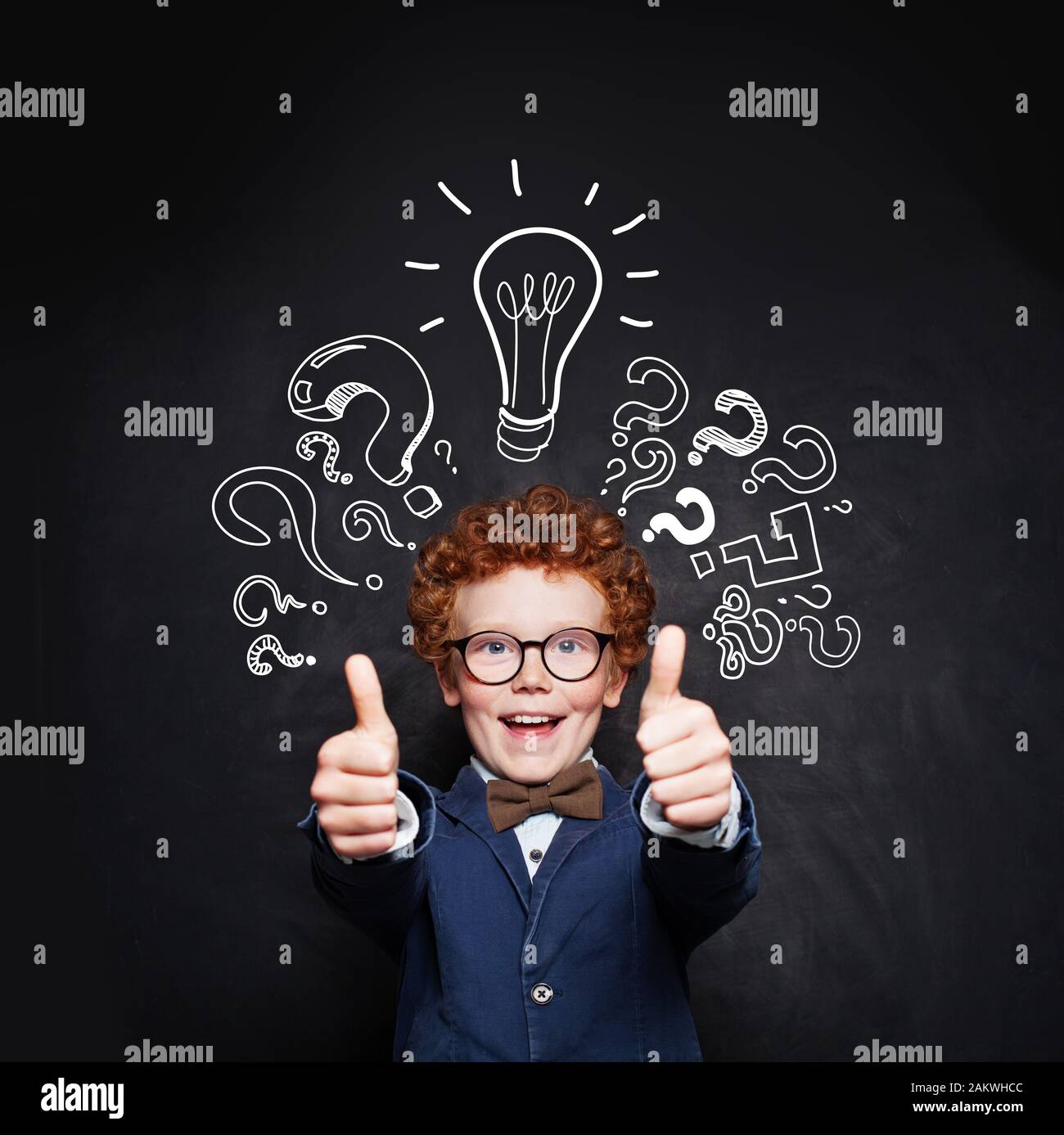 Child boy having fun on blackboard background with lightbulb Stock ...