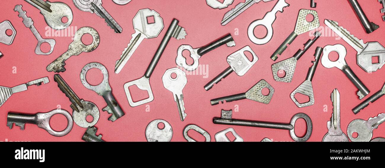 Keys set on pink background. Door lock keys and safes for property ...