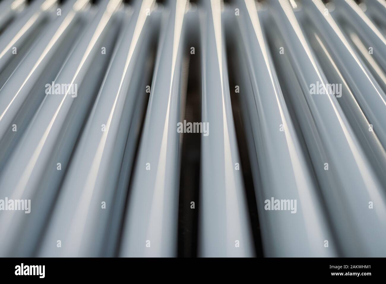 Heating radiator in office, close up. White heat exchangers. Iron ...