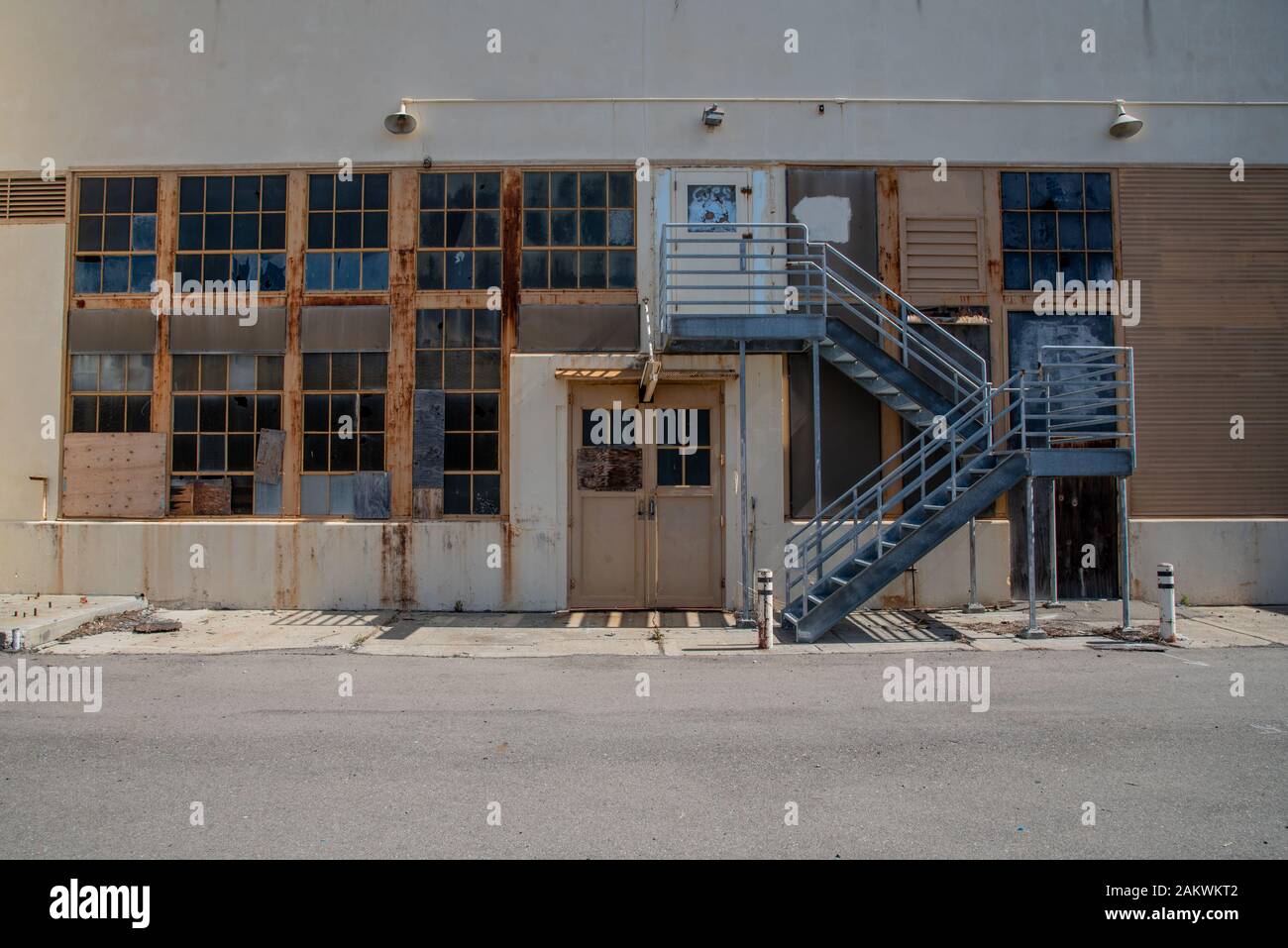 Iron stairs in front of vintage industrial facade of old factory ...
