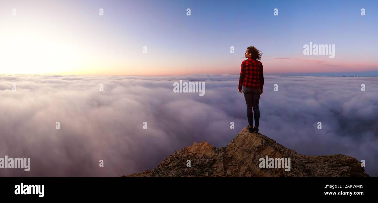Adventurous Girl on a Rocky Mountain above the Clouds Stock Photo - Alamy