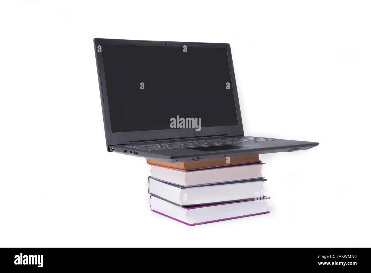 Modern slim laptop on a pile of books Stock Photo - Alamy
