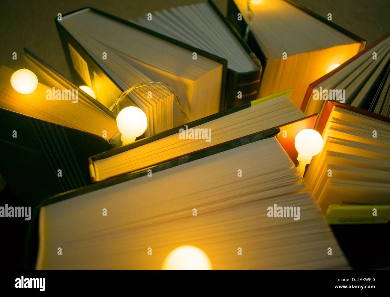 A cozy background from books and small lights Stock Photo - Alamy