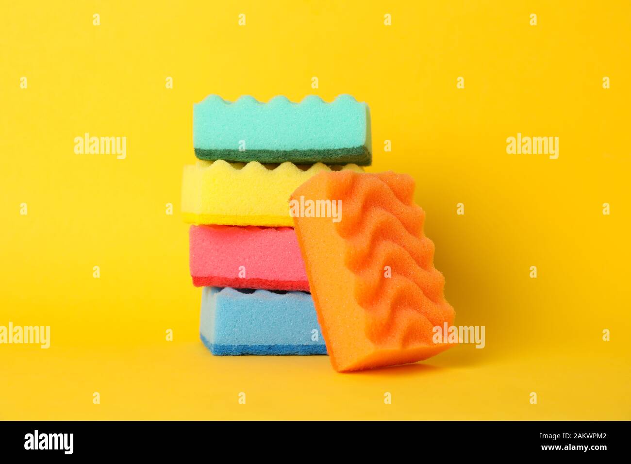 Pile of sponges for washing dishes on yellow background, close up Stock ...