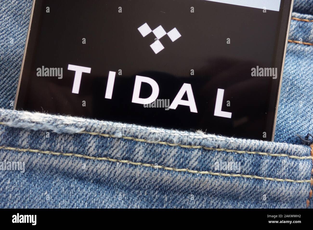 Tidal logo displayed on smartphone hidden in jeans pocket Stock Photo ...