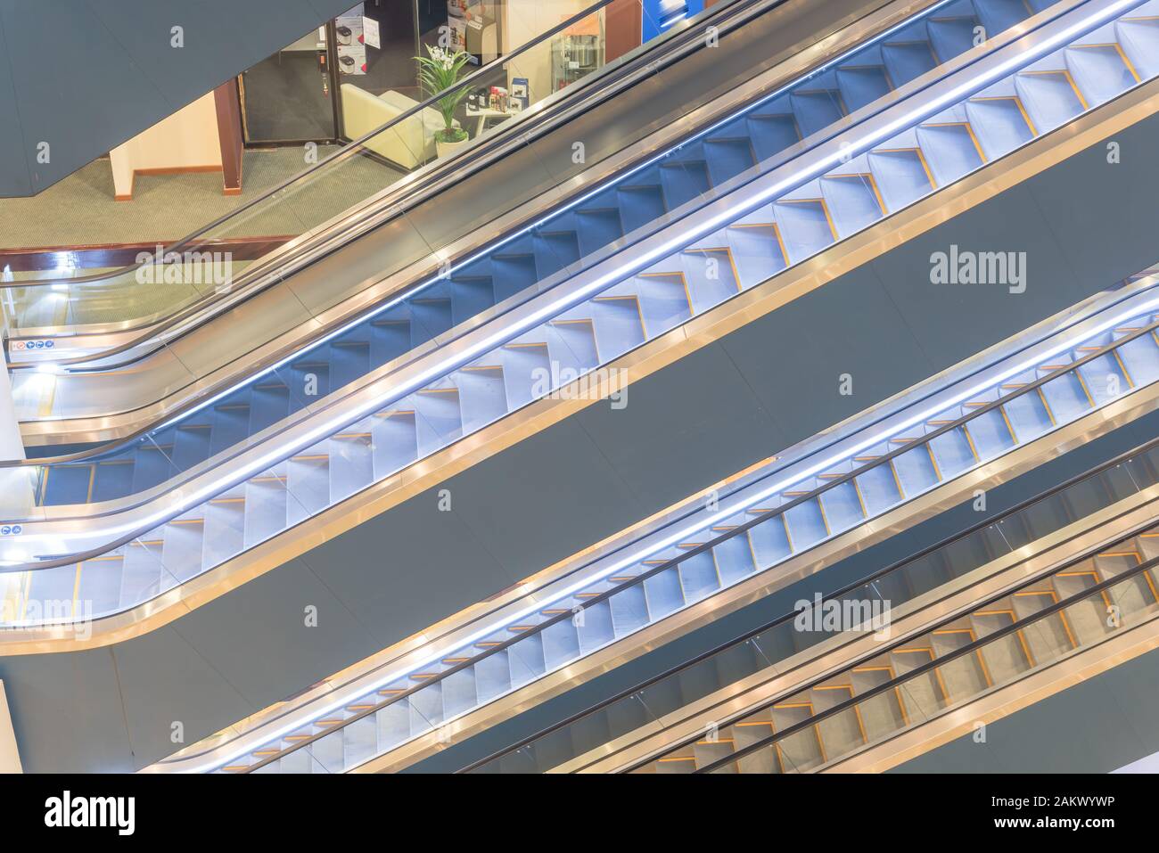 Modern escalator stack on top of each other insider a commercial ...