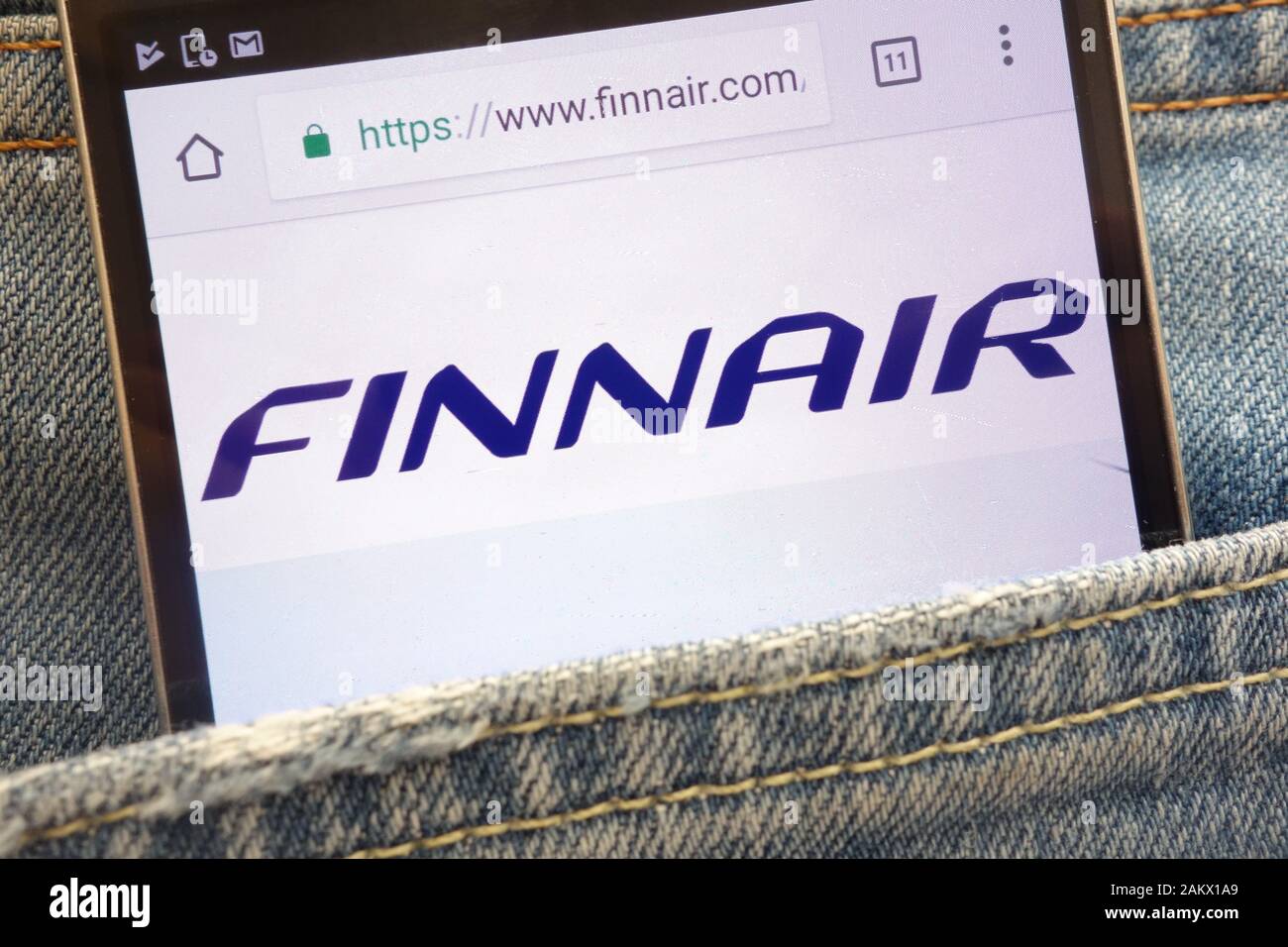 Finnair website displayed on smartphone hidden in jeans pocket Stock ...
