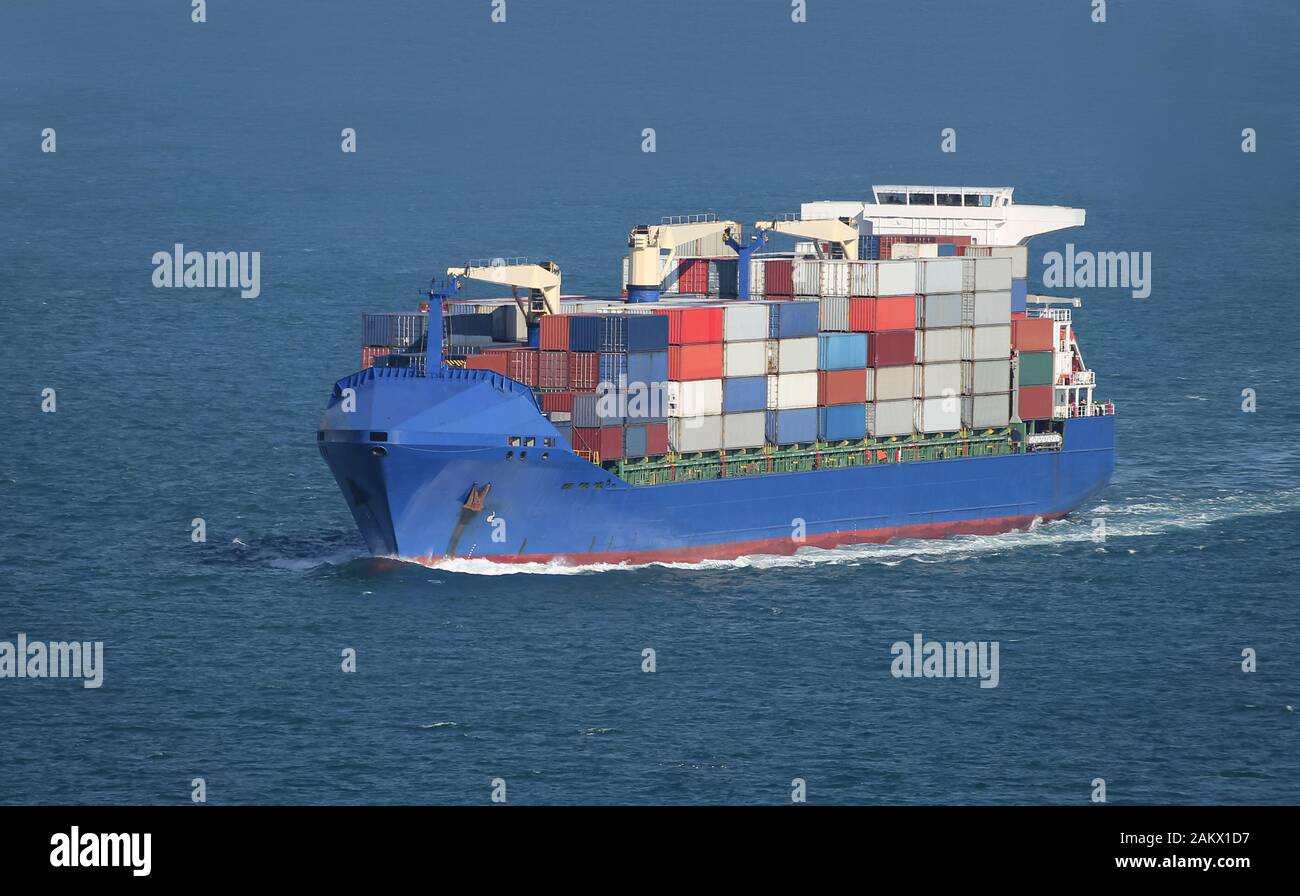 A container ship carrying goods between ports Stock Photo - Alamy