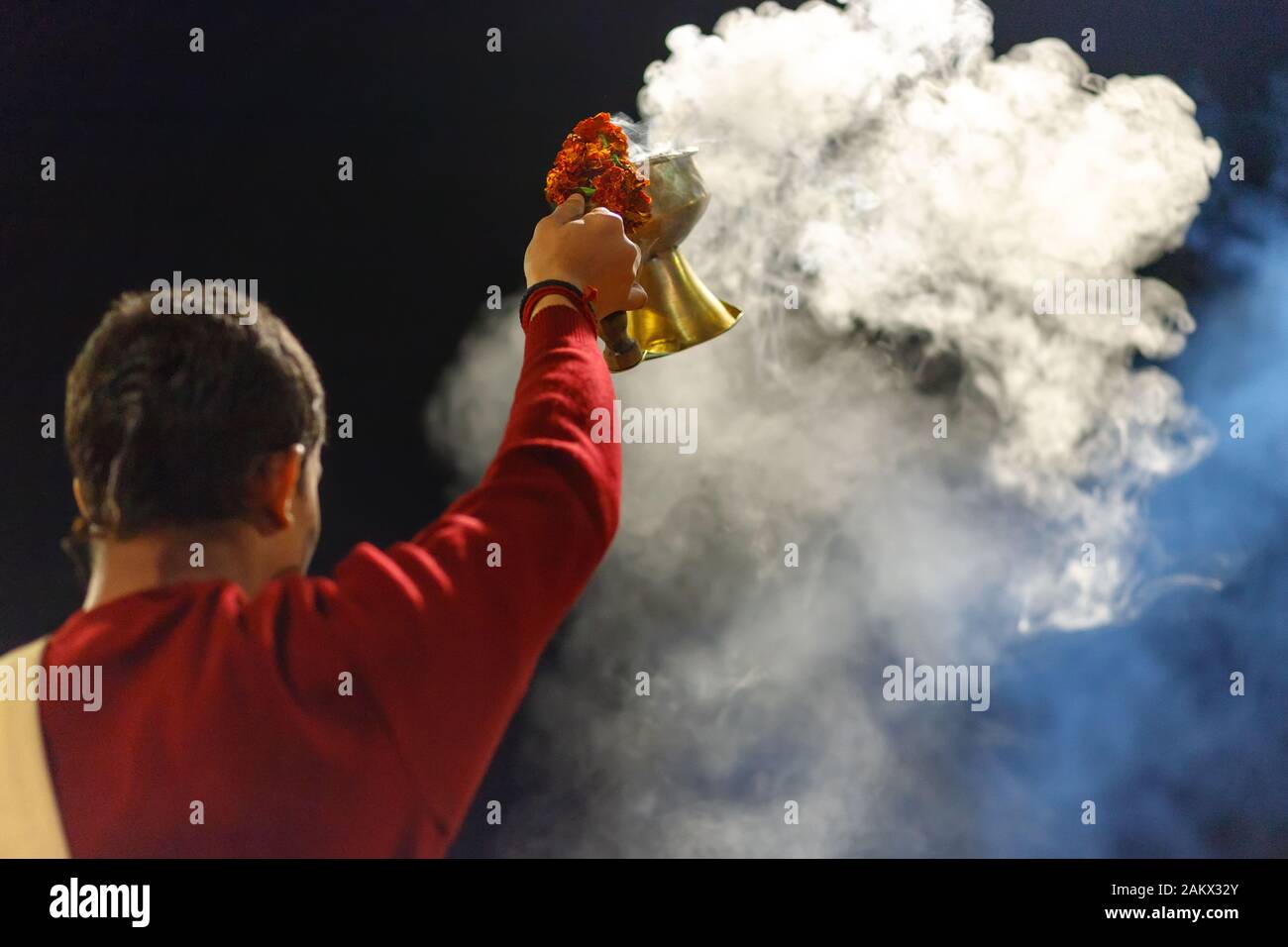 VARANASI, INDIA, JANUARY 17, 2019 : Hindu priest waving incense cup ...