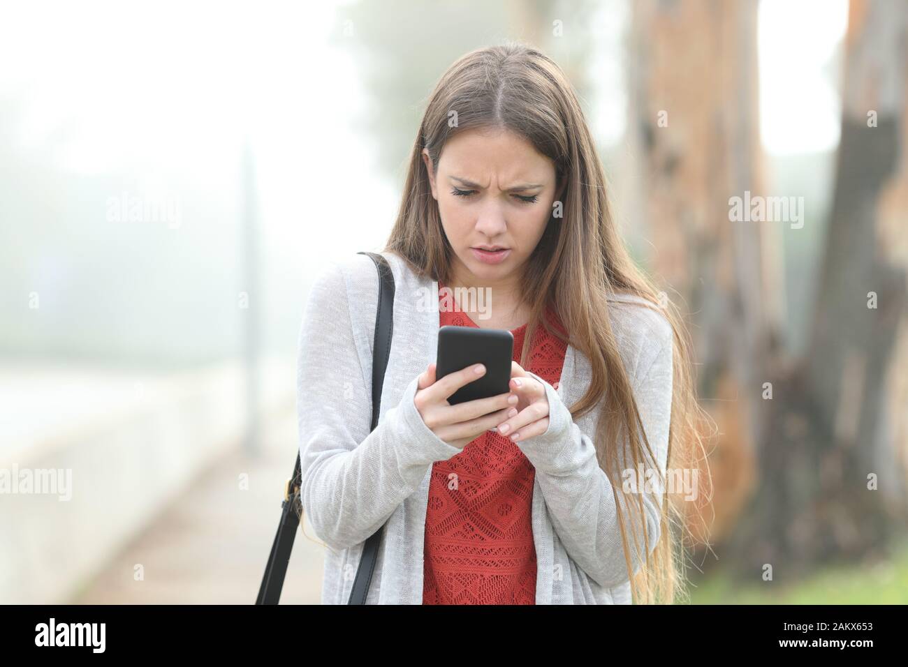 Teen girl walking alone cell phone hi-res stock photography and images ...