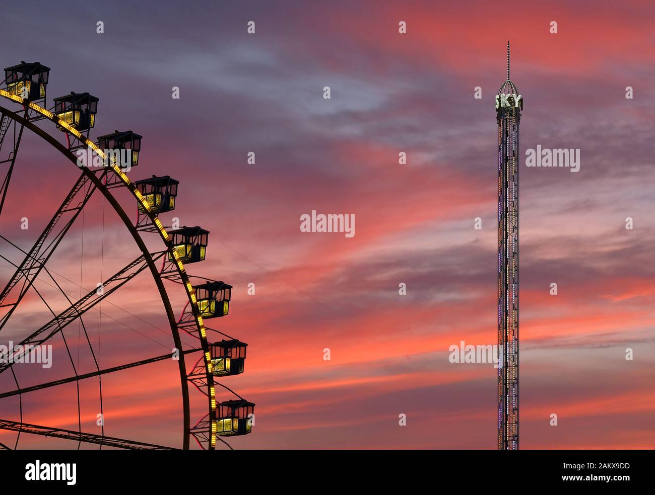 close-up of ferris wheel cabins on fairground against dramatic sunset ...