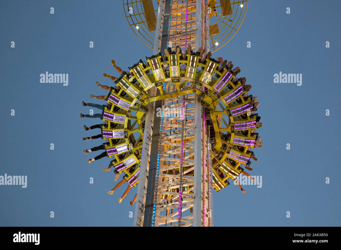 Amusement park ride. Large number of legs high up in the air against ...