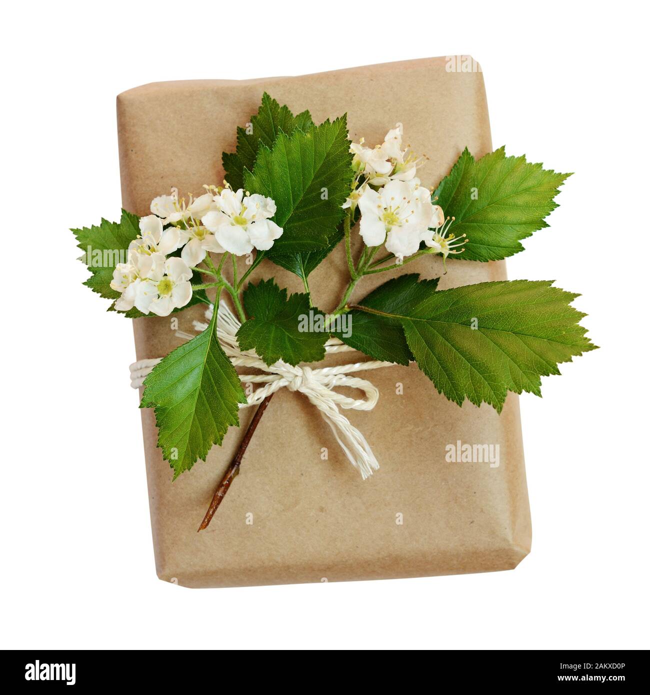 Package wrapped in kraft paper and tied with a rope and flowers ...