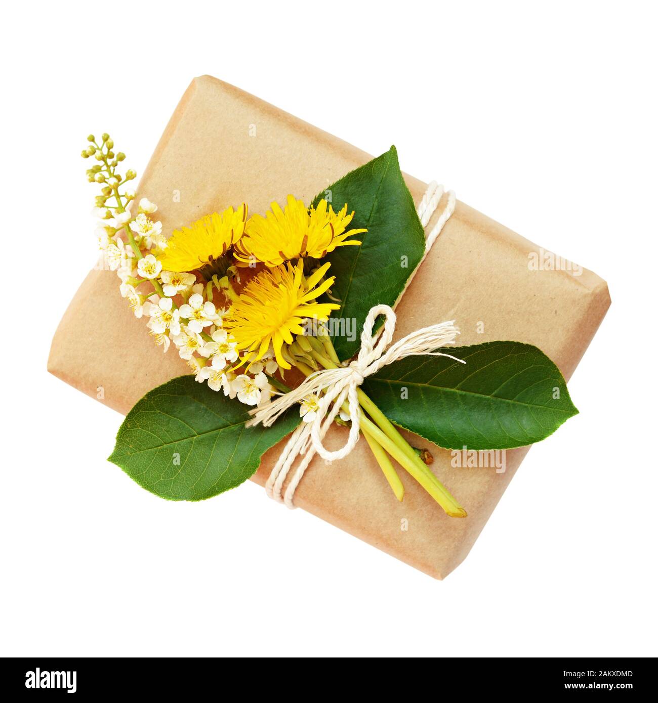 Package wrapped in paper and tied with a rope and bouquet of flowers ...
