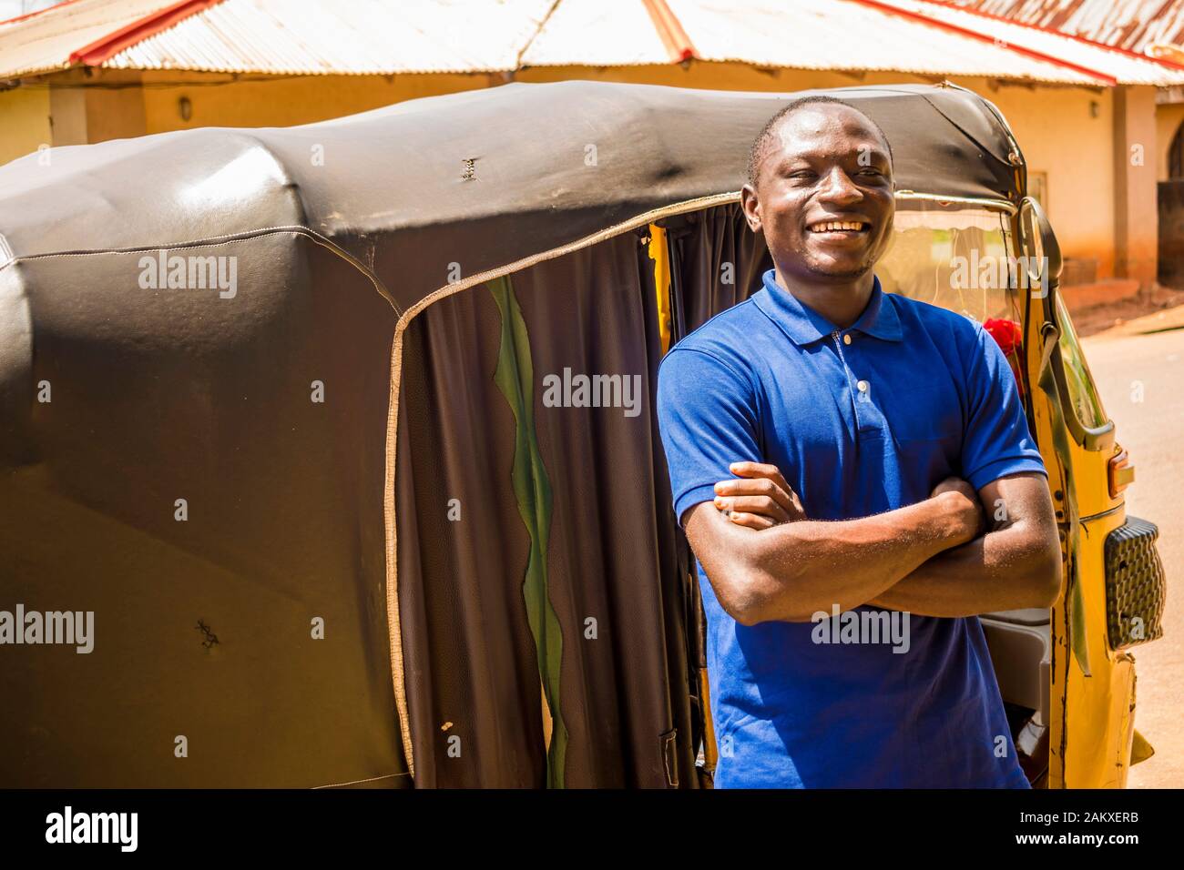 young african man driving a rickshaw taxi counting his money smiling ...