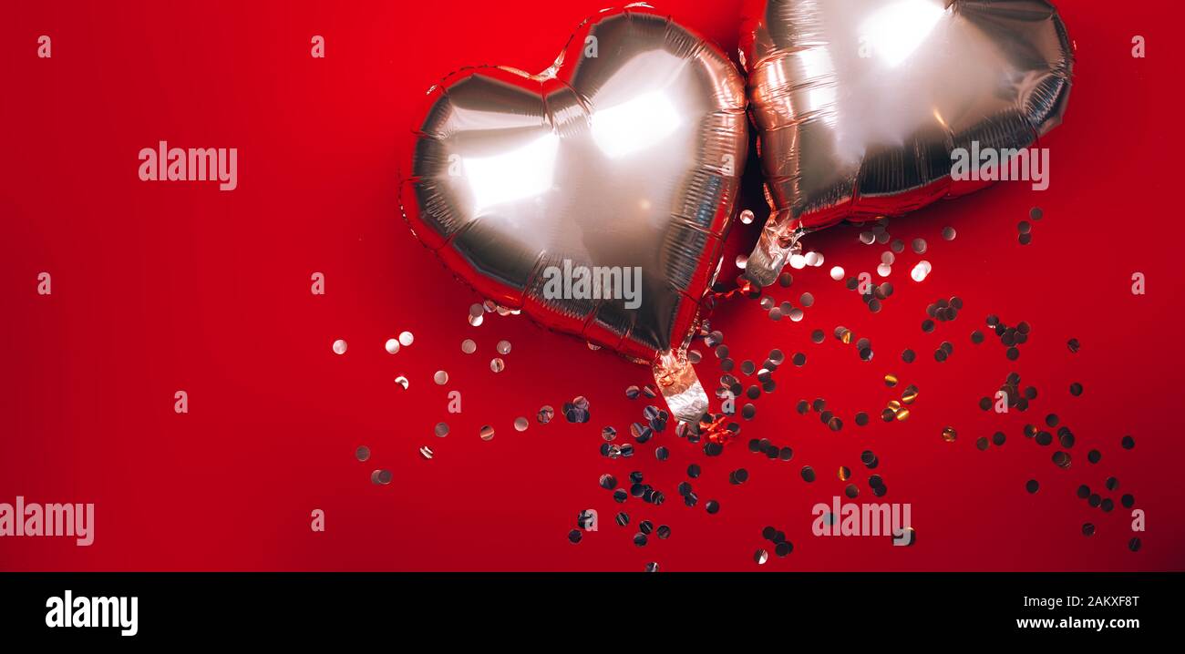 Two baloons heart shape on red background Stock Photo - Alamy