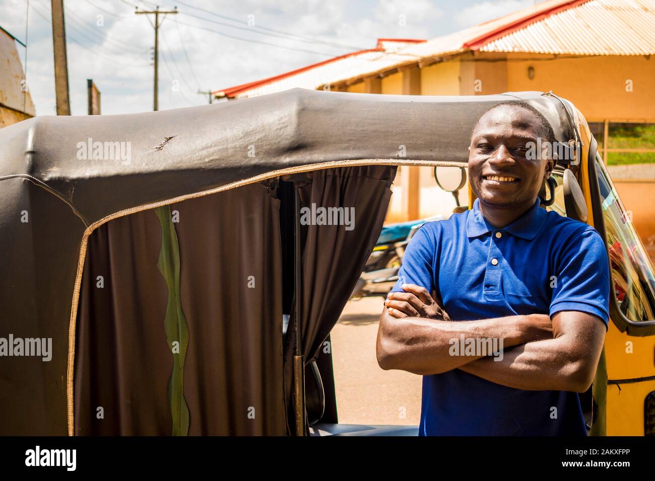 young african man driving a rickshaw taxi counting his money smiling ...