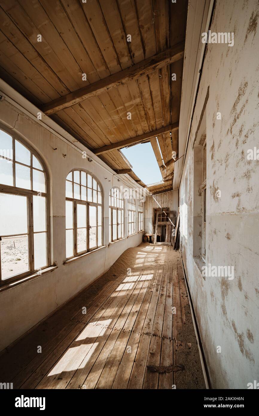 beautiful western villa with big windows and desert sand coverding the ...