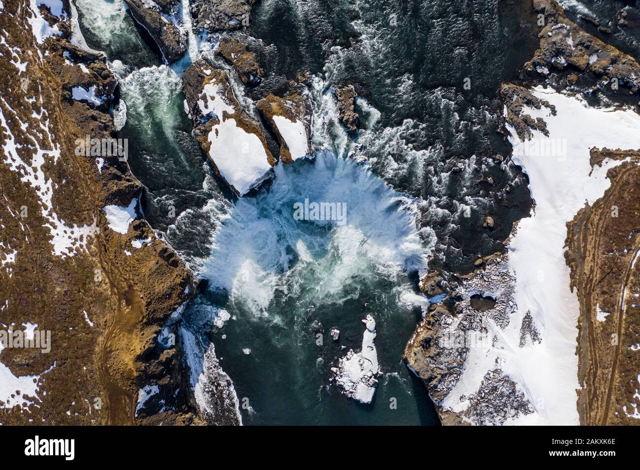 Aerial view of Godafoss waterfall, snowy shore and river. Iceland in ...