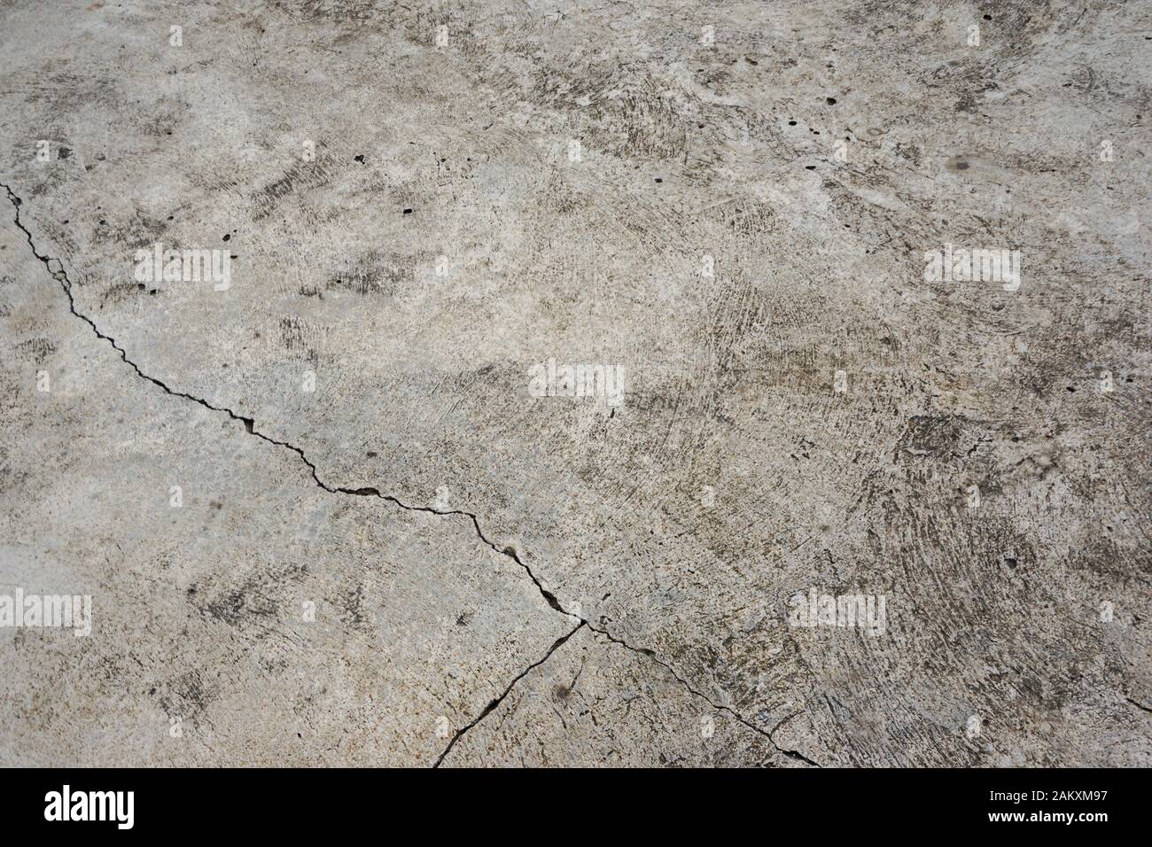 The cement floor is not grey. There are cracks. Divide the cement into ...