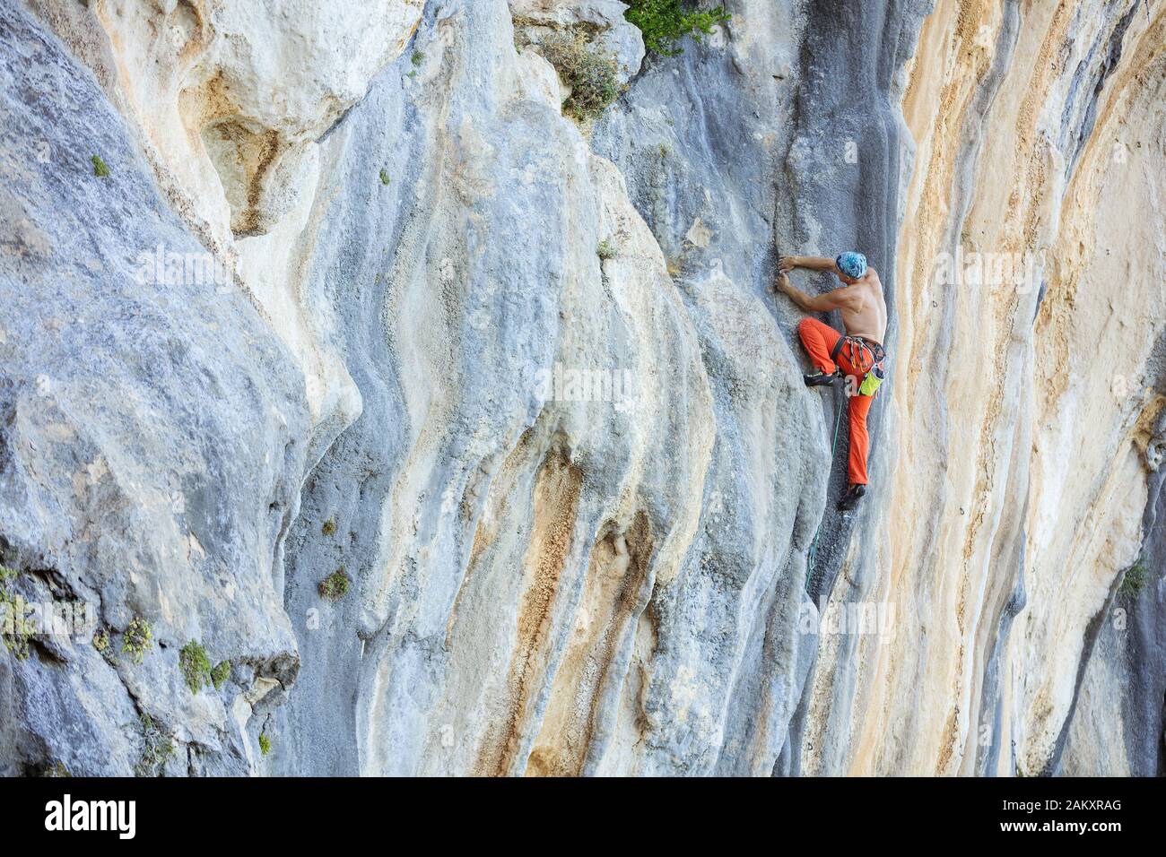 Caucasian young man climbing challenging route on cliff Stock Photo - Alamy