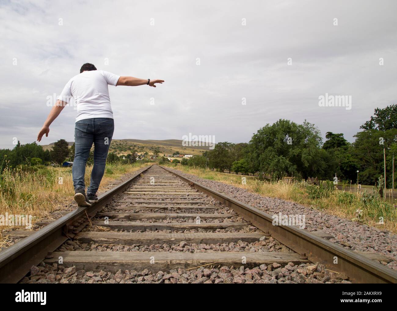 Man walking on railroad tracks hi-res stock photography and images - Alamy