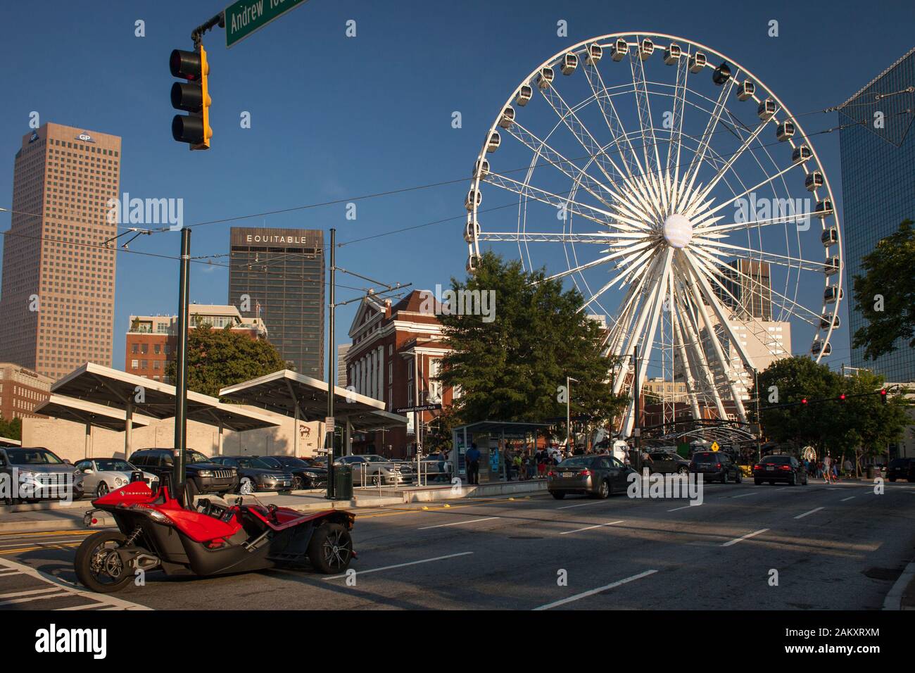 Horizontal shot of a red car with three wheels at Centennial Olympic ...