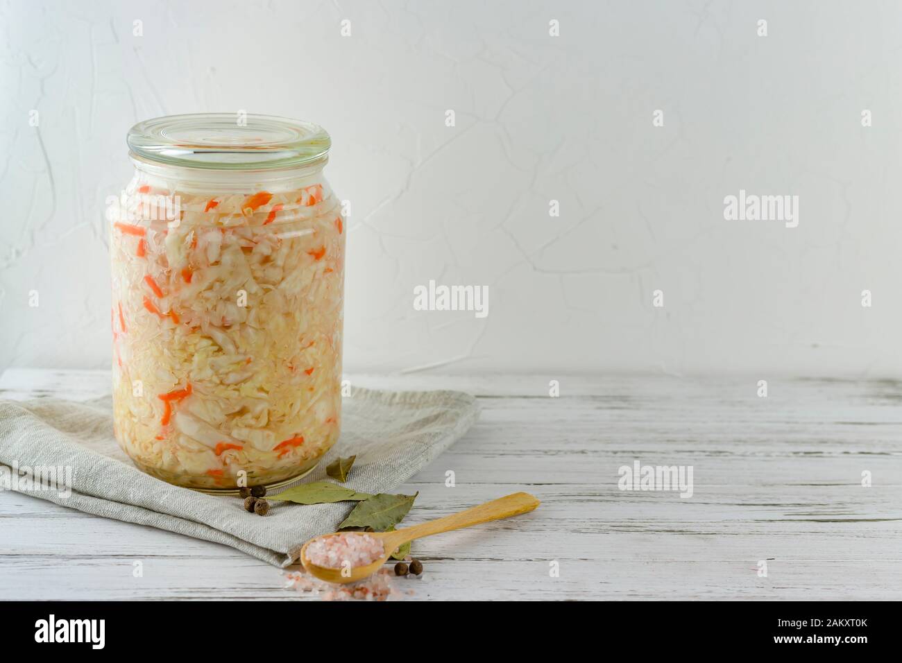 glass jar of fermented white cabbage. vegetables on a light background ...