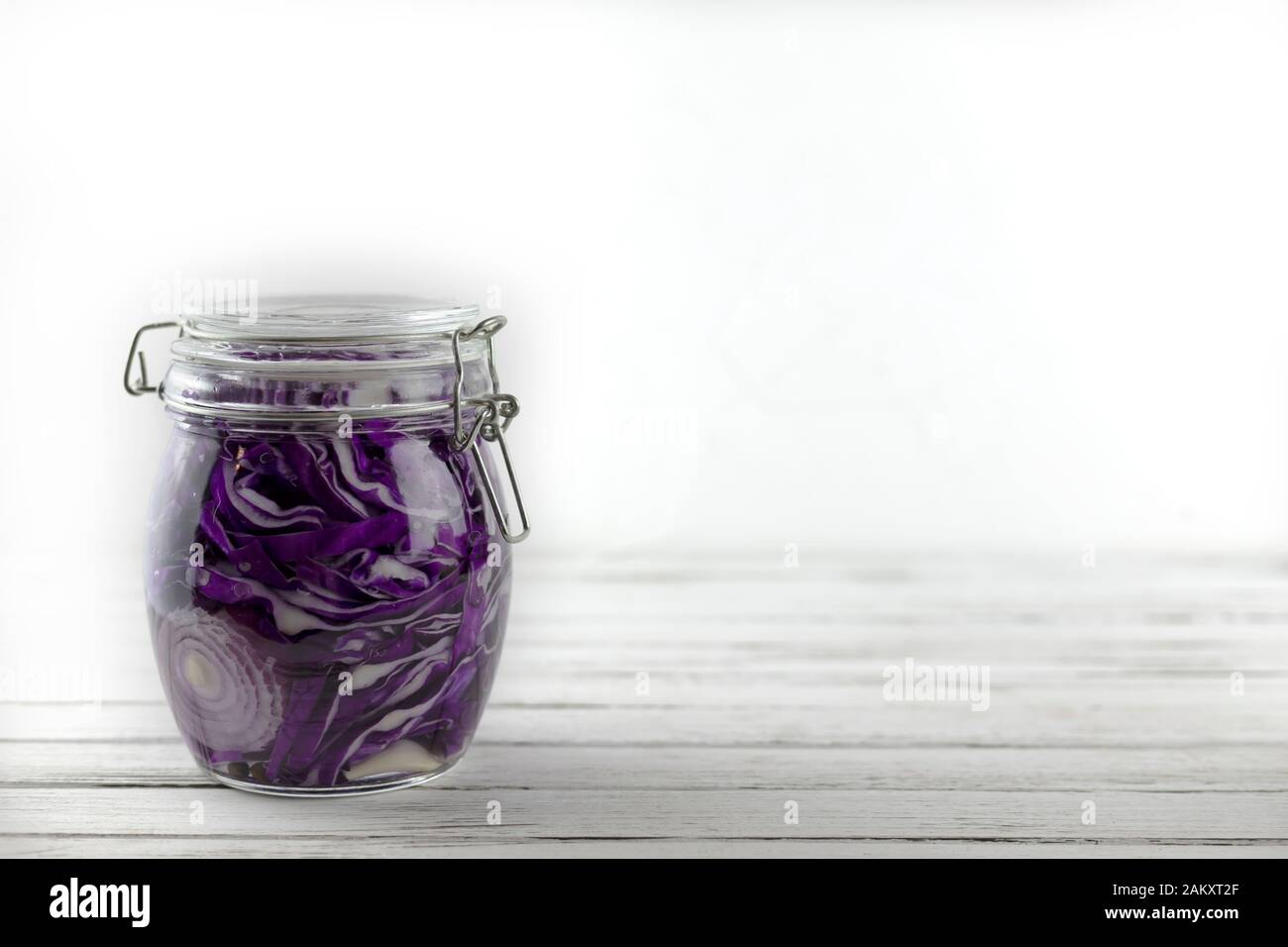 glass jar of fermented red cabbage. vegetables on a light background ...