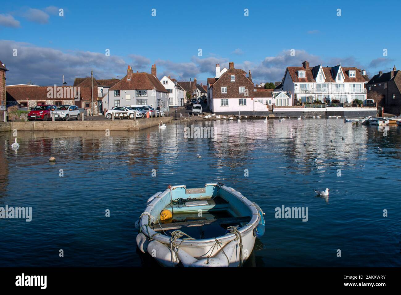 Emsworth harbour view of an old boat and swans in the background where ...