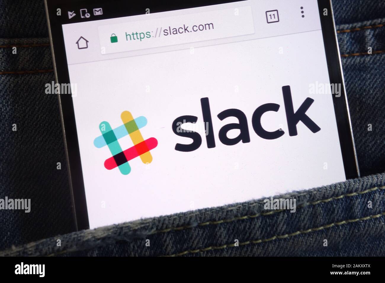 Slack website displayed on smartphone hidden in jeans pocket Stock ...