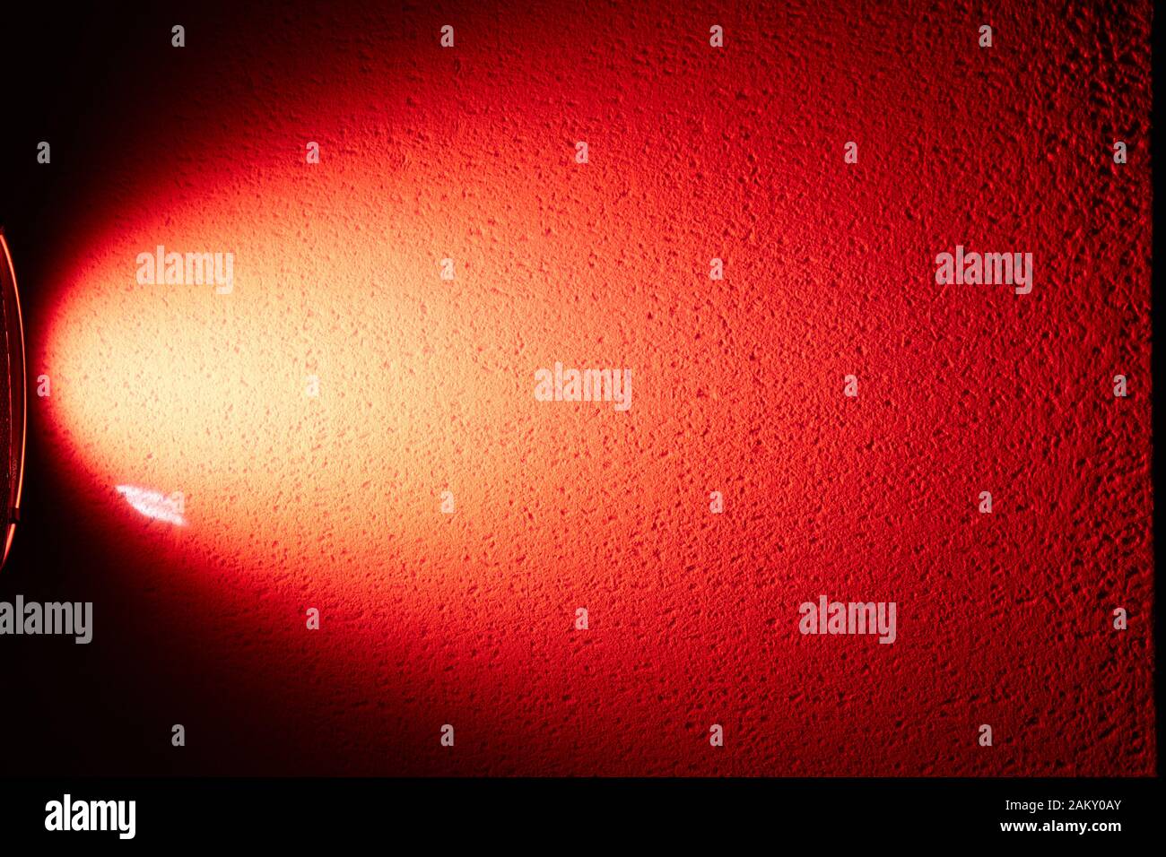 Wide red beam of light on a black background Stock Photo - Alamy