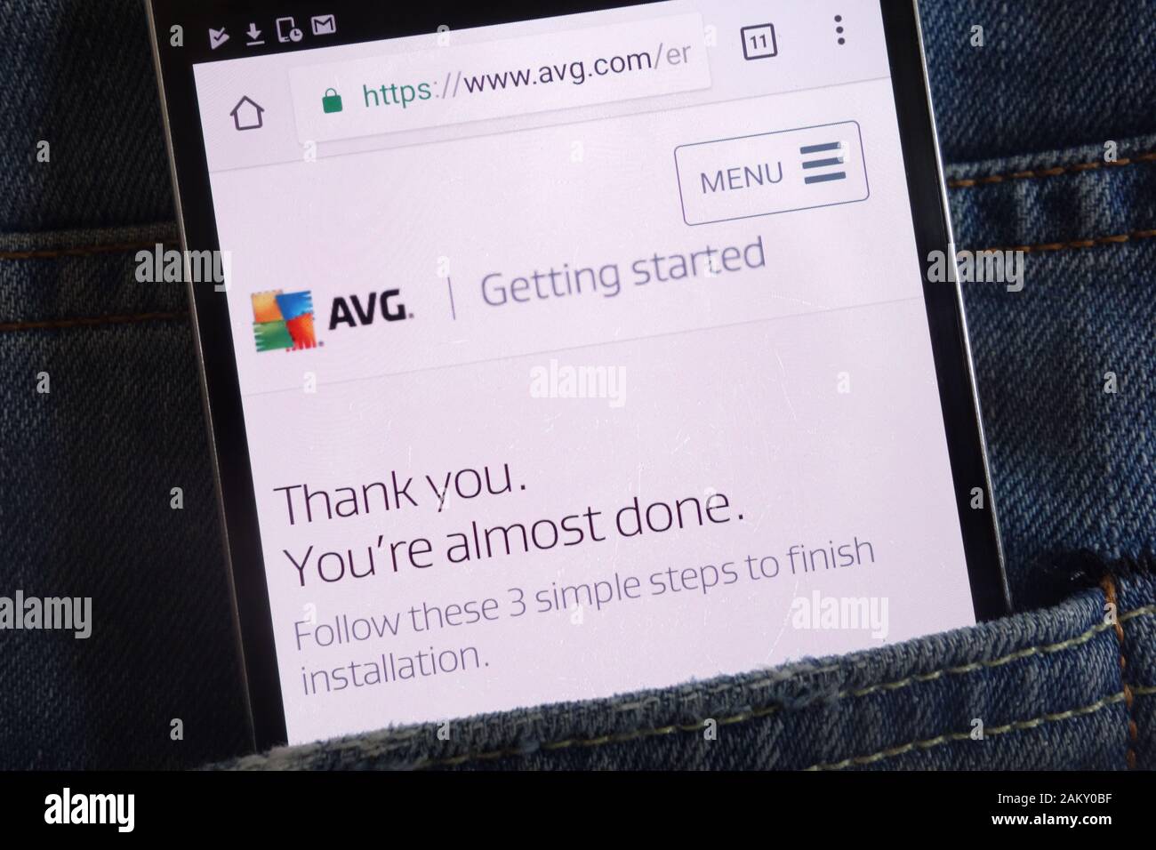 AVG website displayed on smartphone hidden in jeans pocket Stock Photo ...