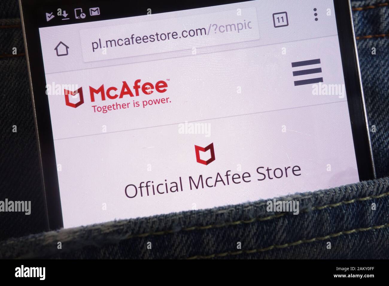 McAfee Store website displayed on smartphone hidden in jeans pocket ...
