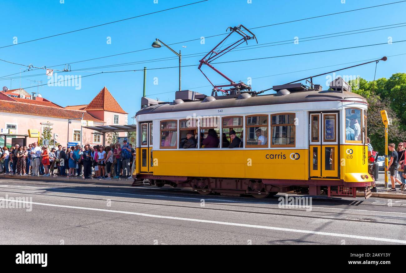 Traditional yellow trams at the streets of Lisboa Stock Photo - Alamy