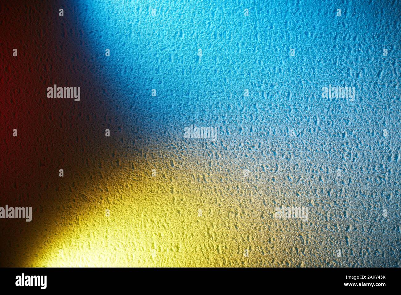 Merging yellow and blue on the same background with a red spot Stock ...