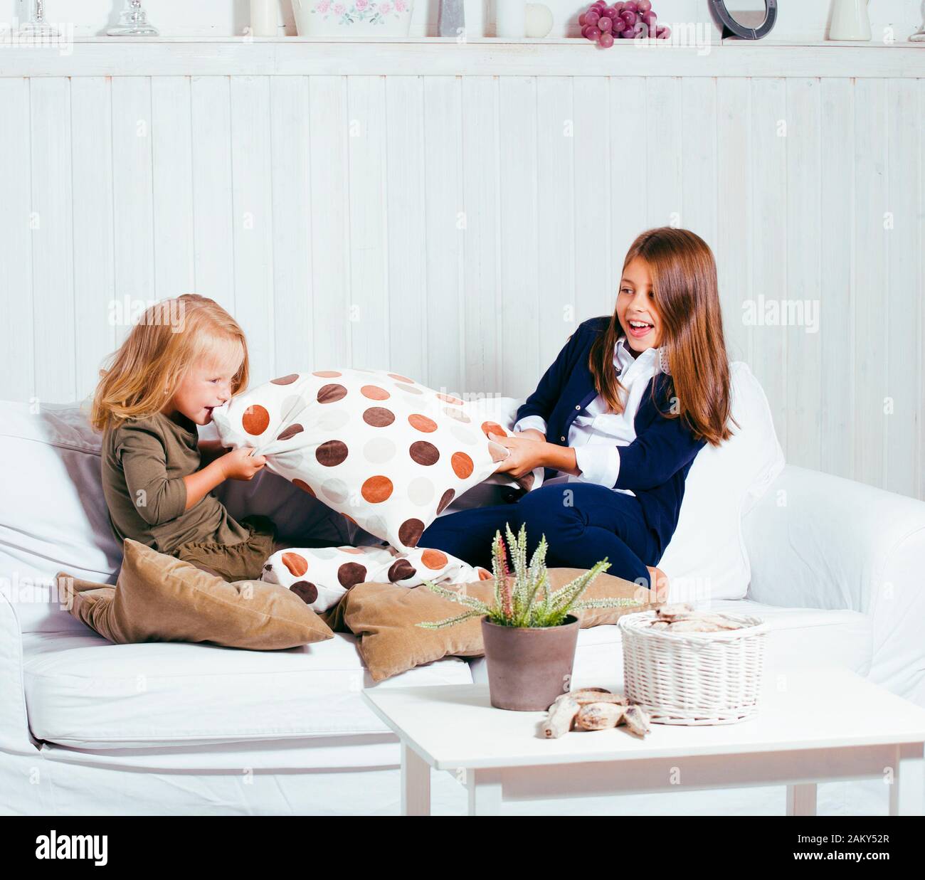 two cute sisters at home playing, little smiling girl in house interior ...