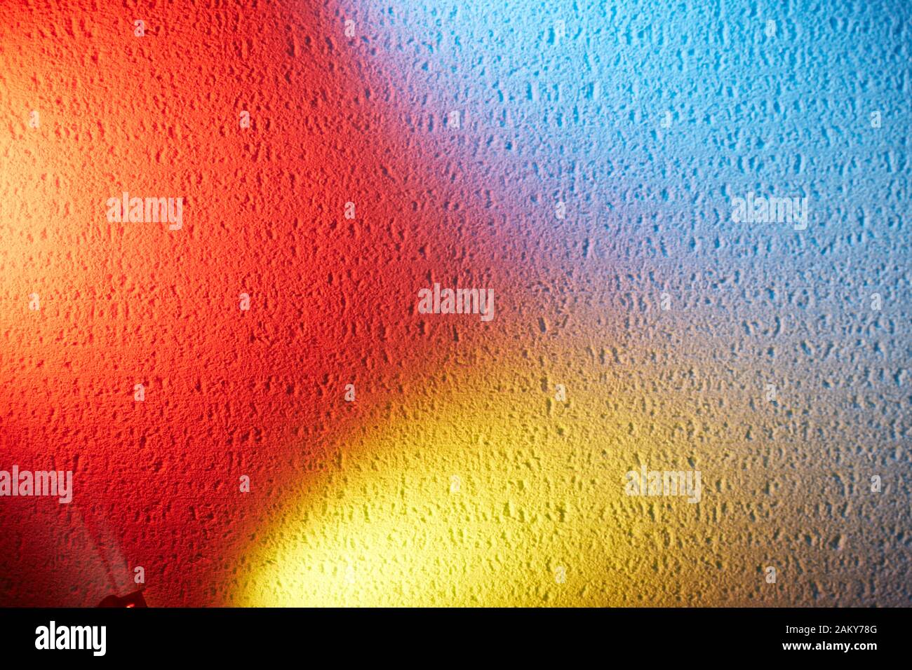 Merging red blue and yellow on one textural background Stock Photo - Alamy