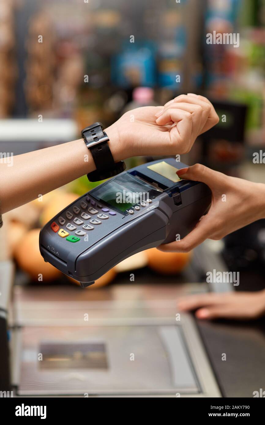 Paying cashless pos terminal her smartwatch hi-res stock photography ...