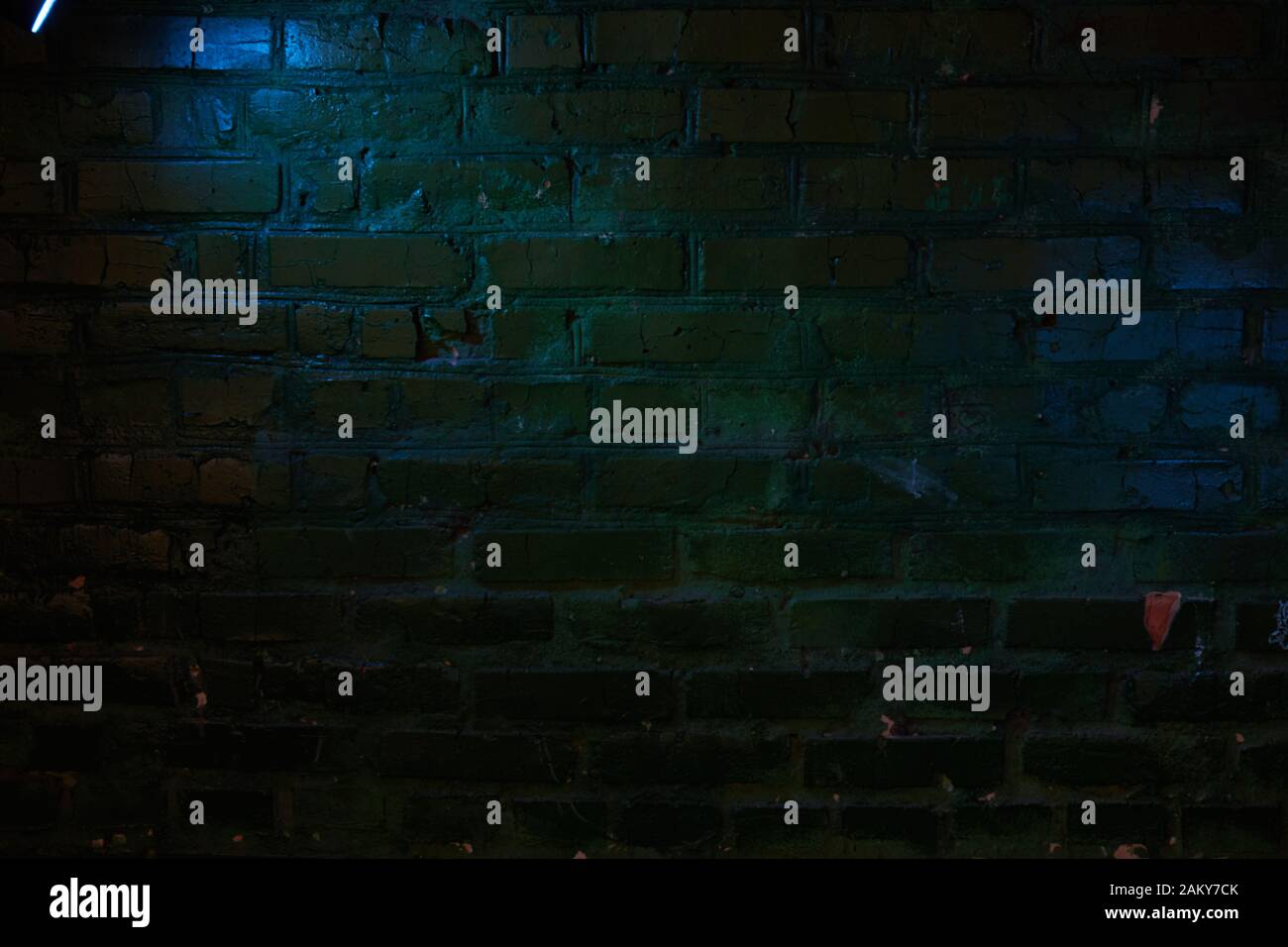 On the green brick wall blue light lantern Stock Photo - Alamy