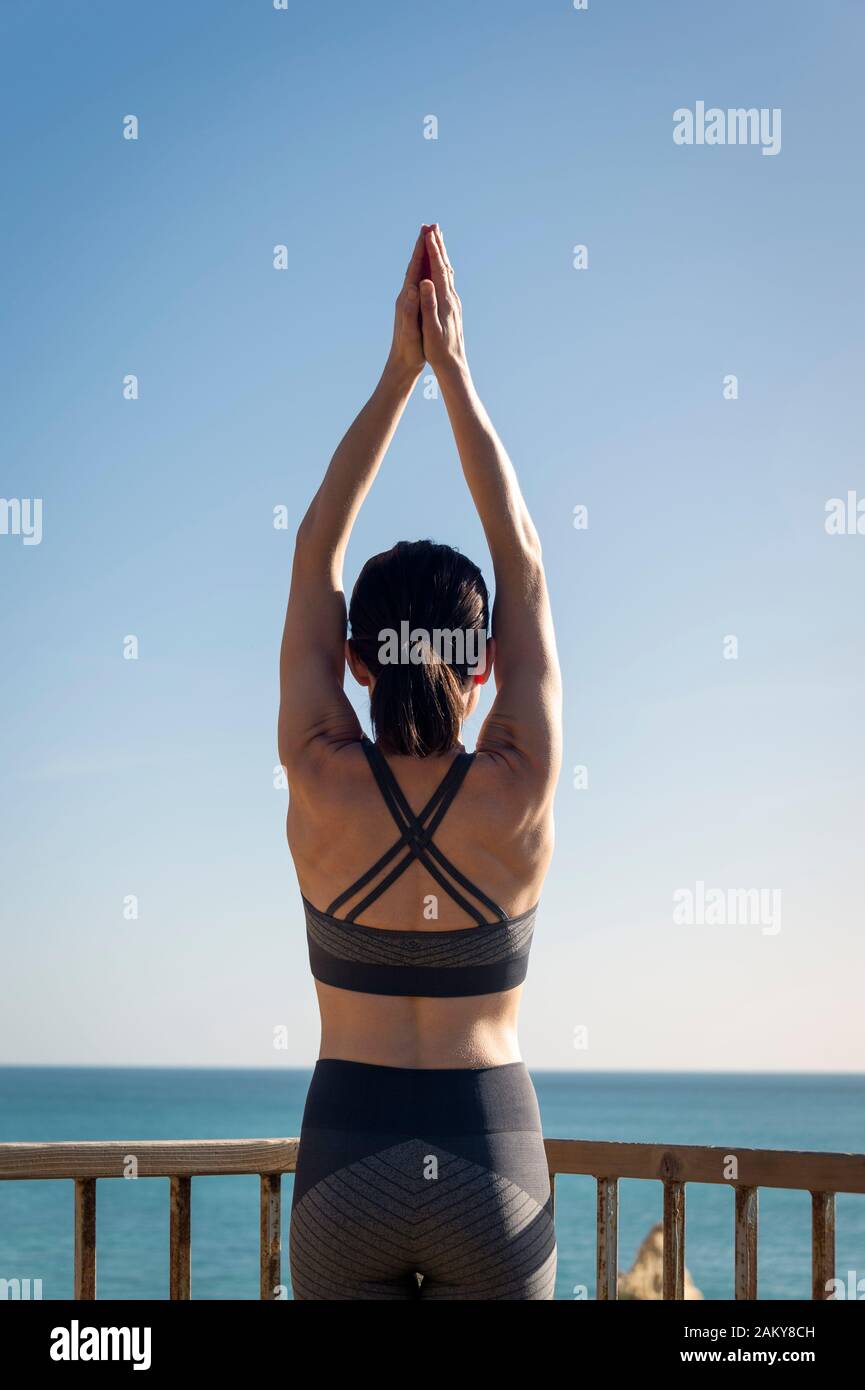 woman doing yoga moutain pose, back view Stock Photo - Alamy