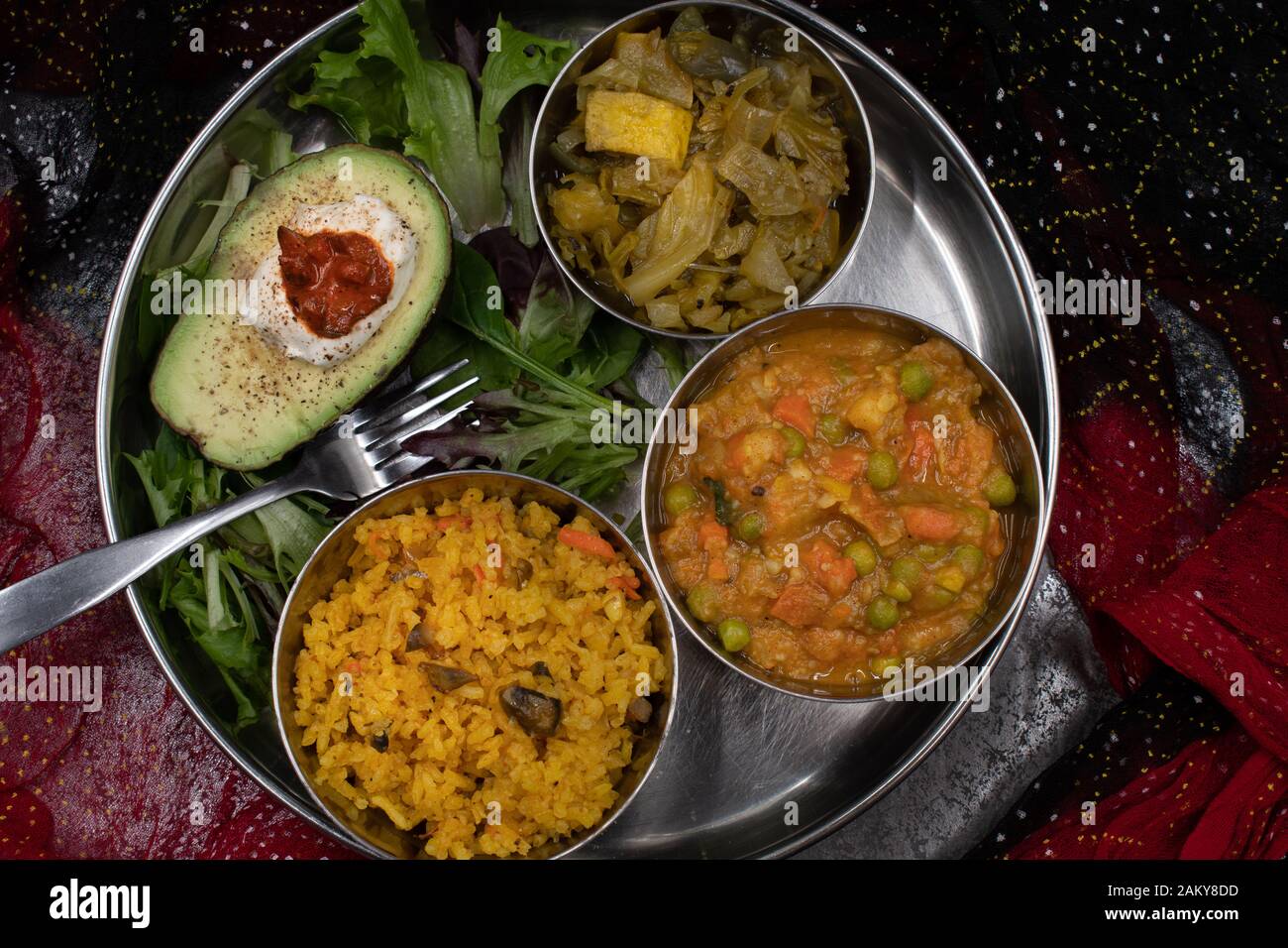 Indian food platter with serving bowls: mixed veggetable curry, cabbage ...
