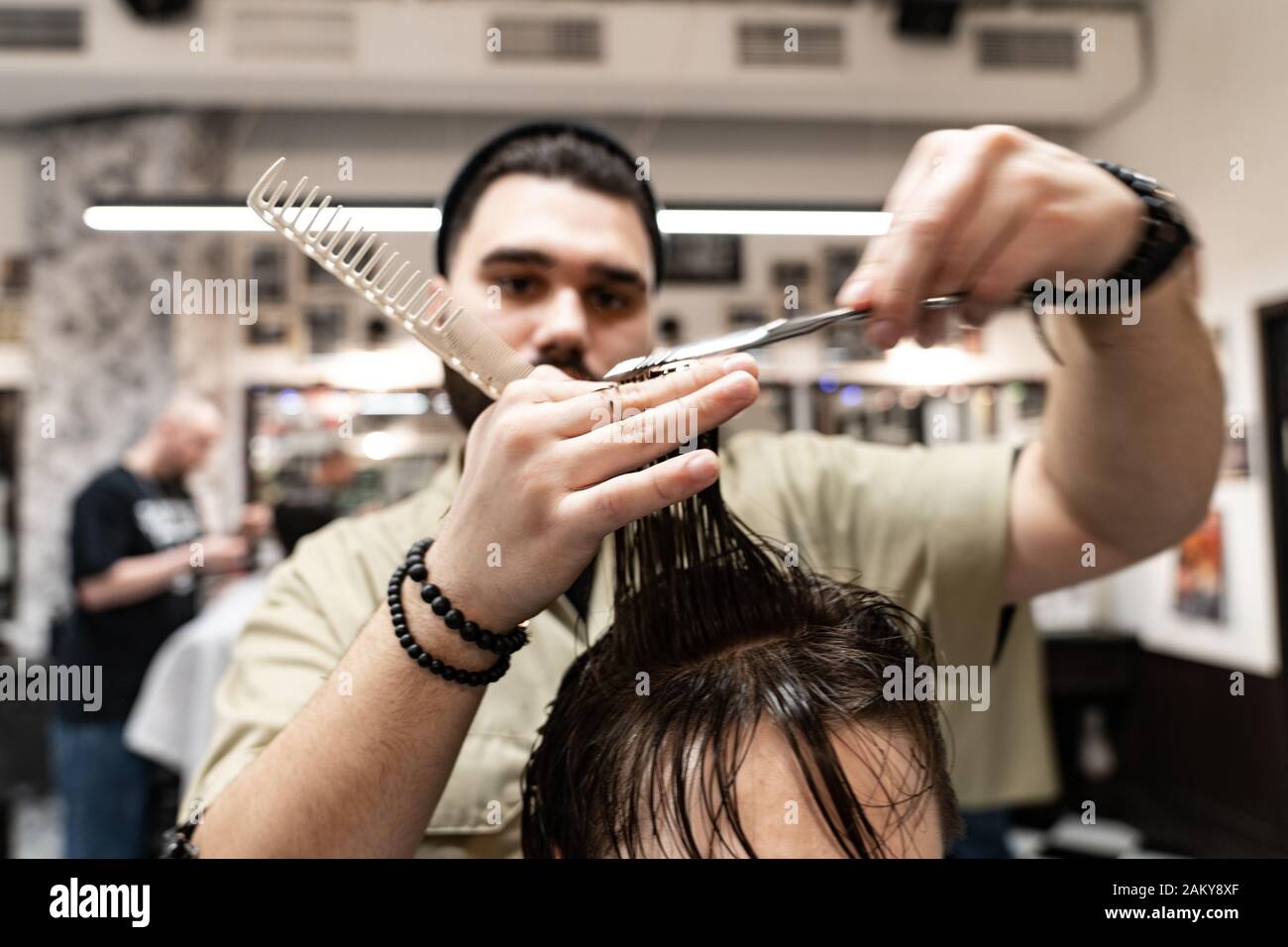 Creating a new hairstyle. Creative haircut from a hairdresser. Men's ...