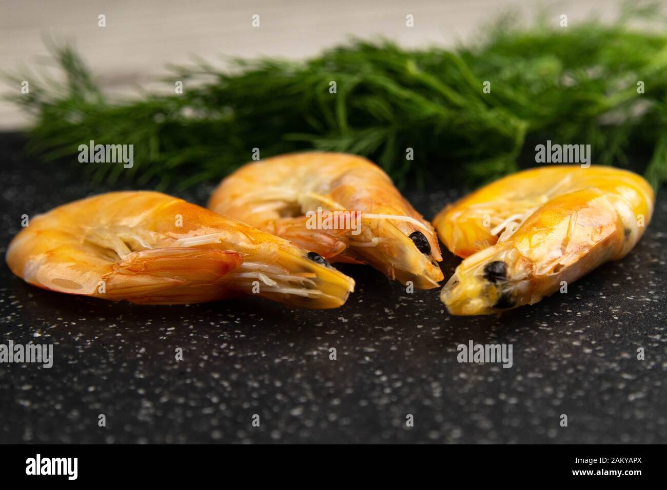 Delicious cooked shrimps on grey marble table krop in the back. Nice ...