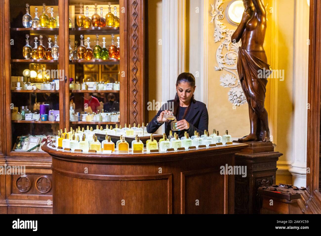 Woman Pouring Perfumes Stock Photo - Alamy