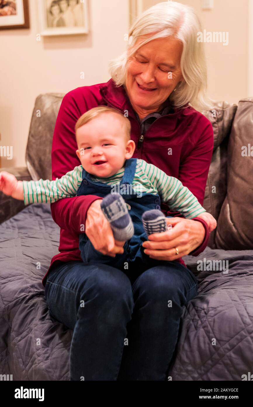 Aunt holding seven month old smiling baby boy Stock Photo - Alamy