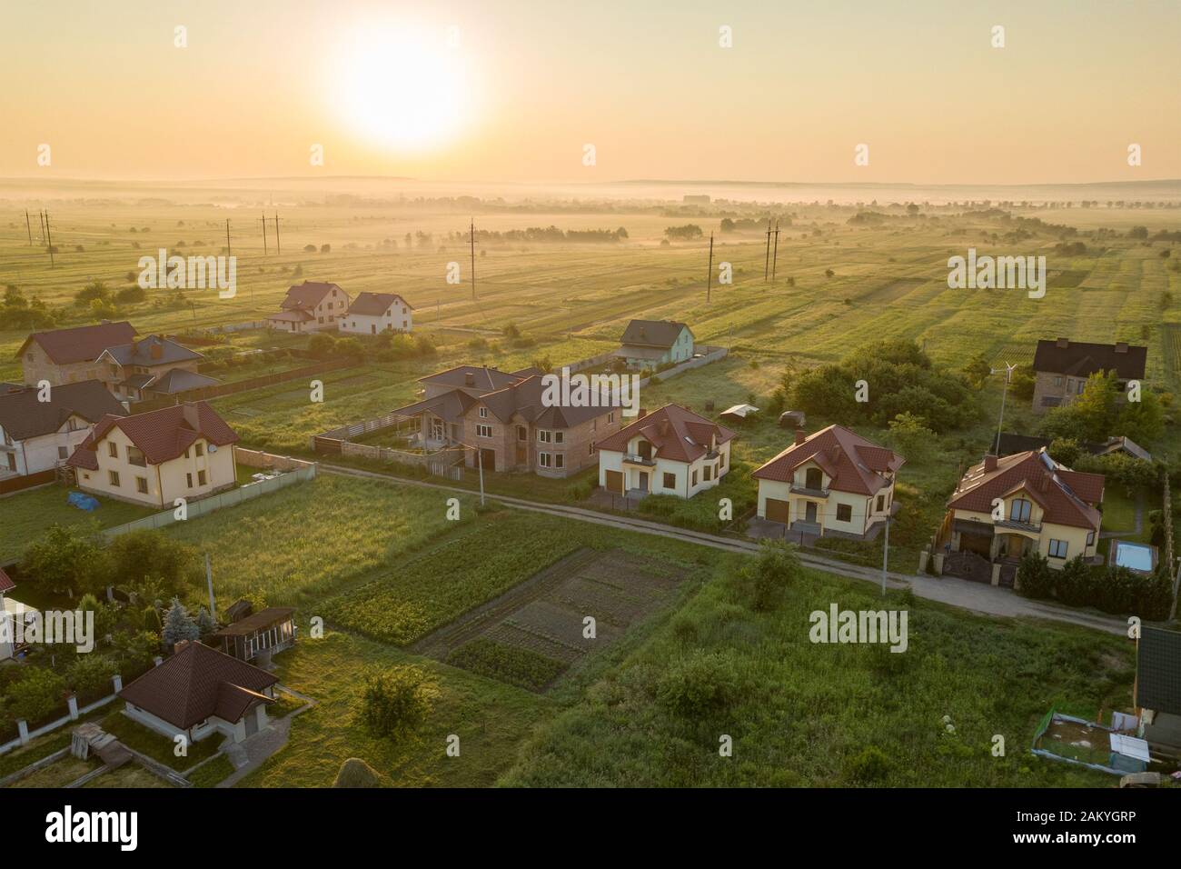 Aerial view of rural residential area with private homes between green ...