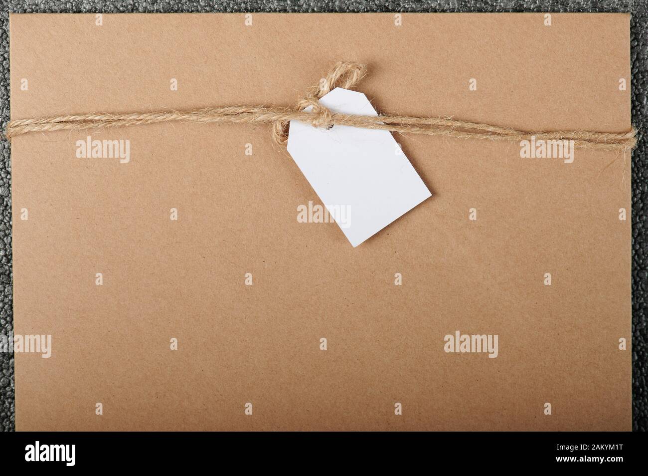 Brown envelop with white paper tag from recycled carton Stock Photo - Alamy