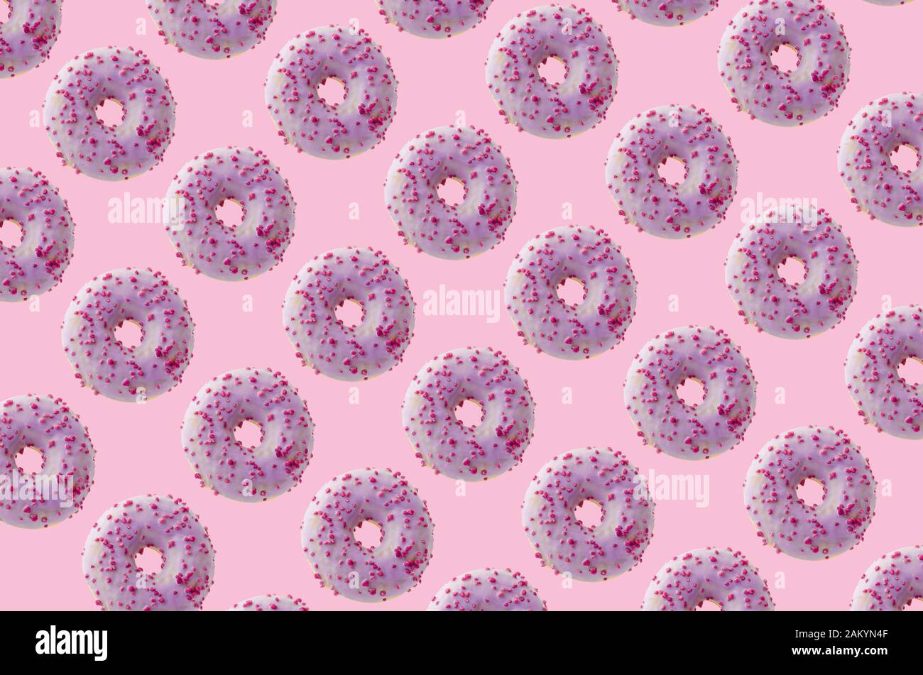 Many purple donuts on pink background. Texture concept Stock Photo - Alamy