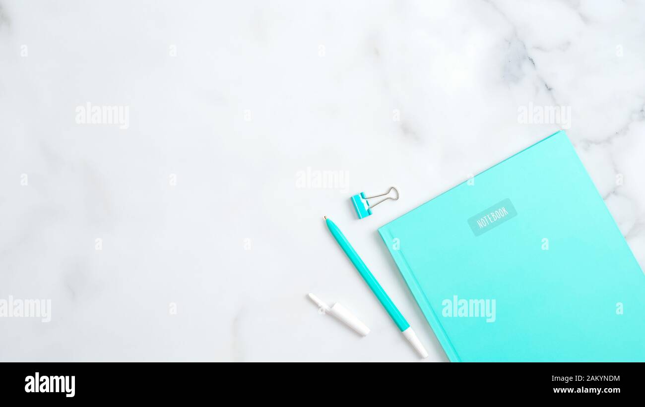 Flat lay mint paper notebook with office supplies on marble background ...